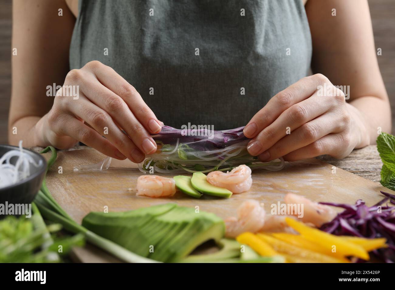 Woman wrapping spring roll hi-res stock photography and images - Alamy