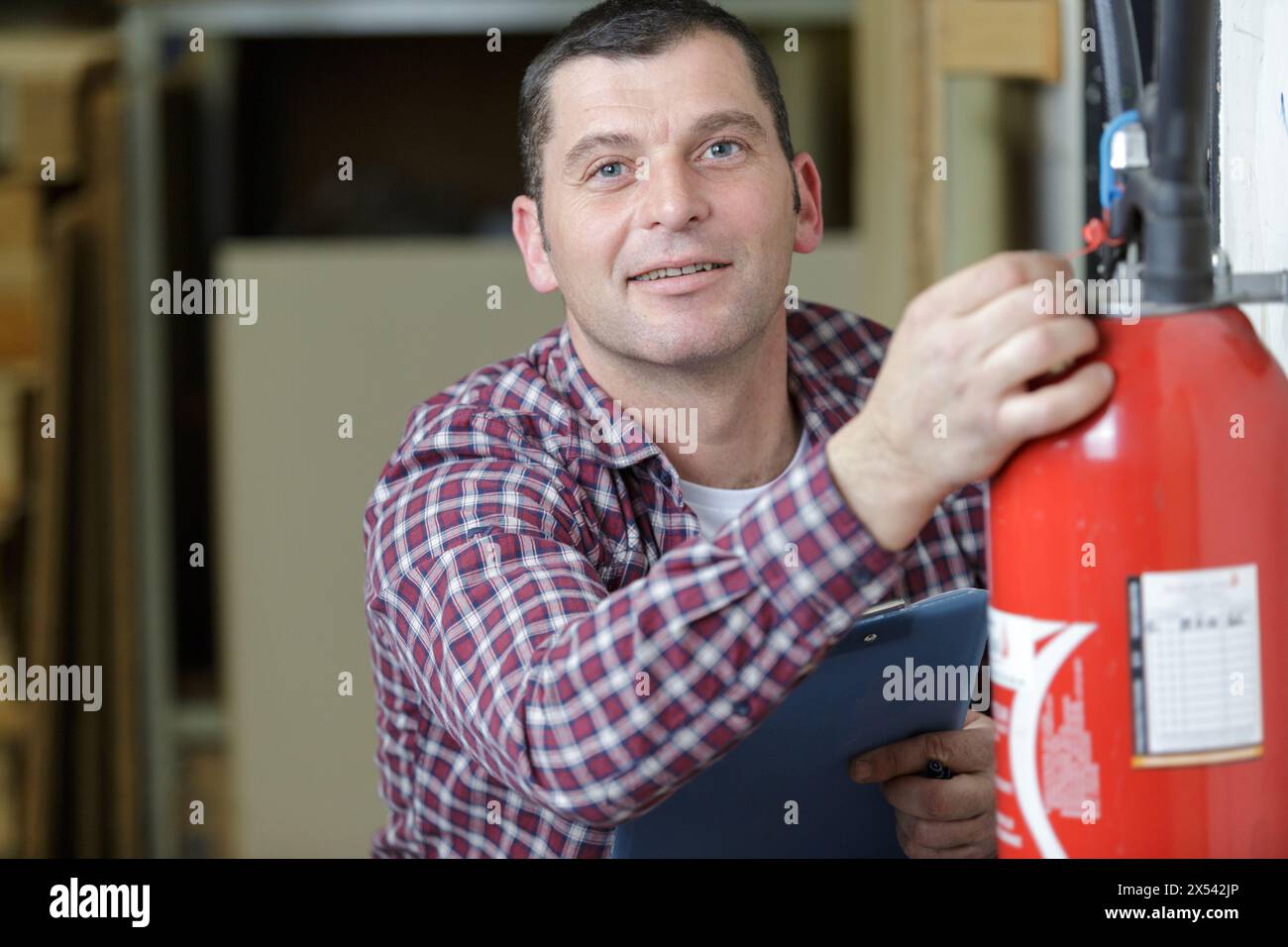 an engineer inspection fire extinguishers Stock Photo - Alamy