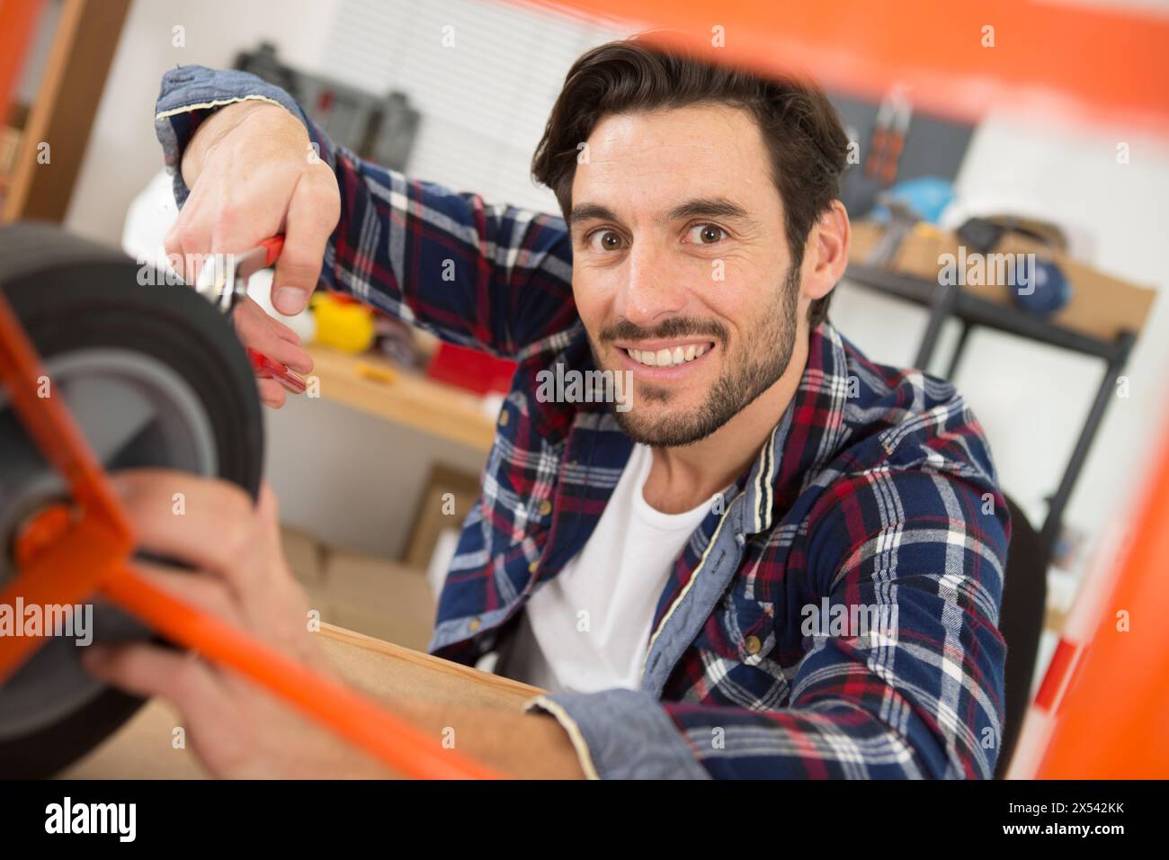 man fixing trolley wheel good quality Stock Photo - Alamy