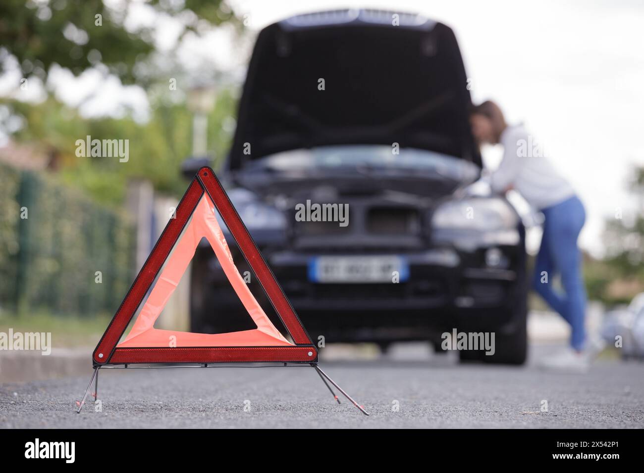 a broken car a triangle sign Stock Photo - Alamy