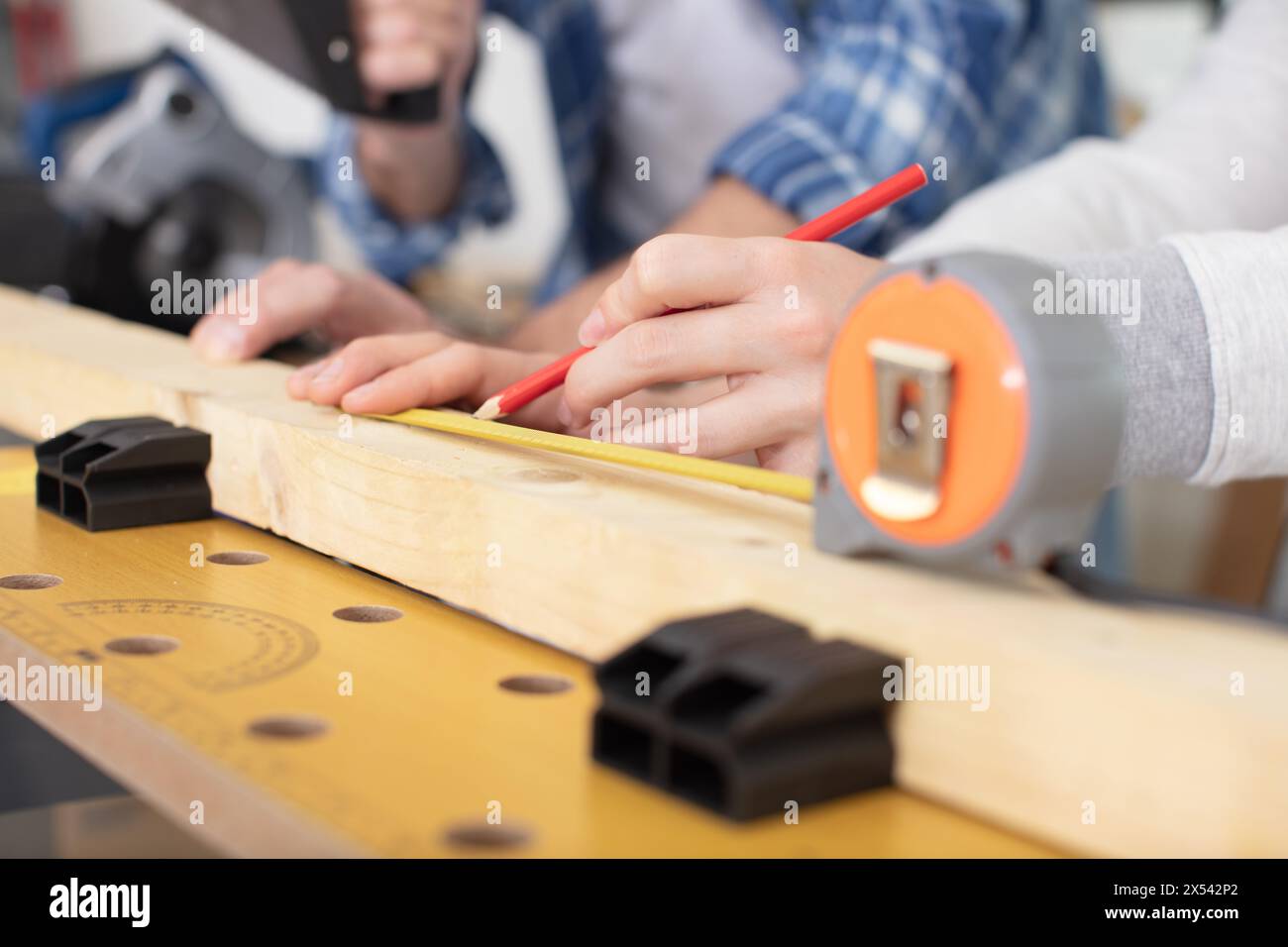 craftsman measuring wooden plank with ruler Stock Photo - Alamy