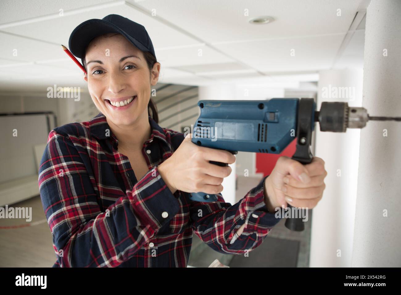 woman drilling into a wooden plank Stock Photo - Alamy