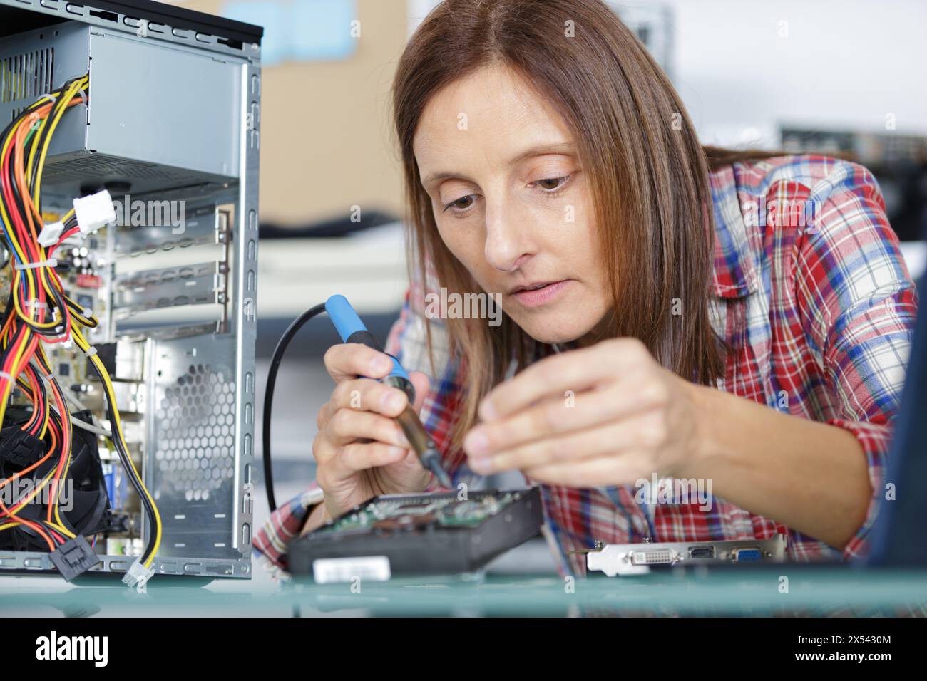 Woman using soldering iron hi-res stock photography and images - Alamy