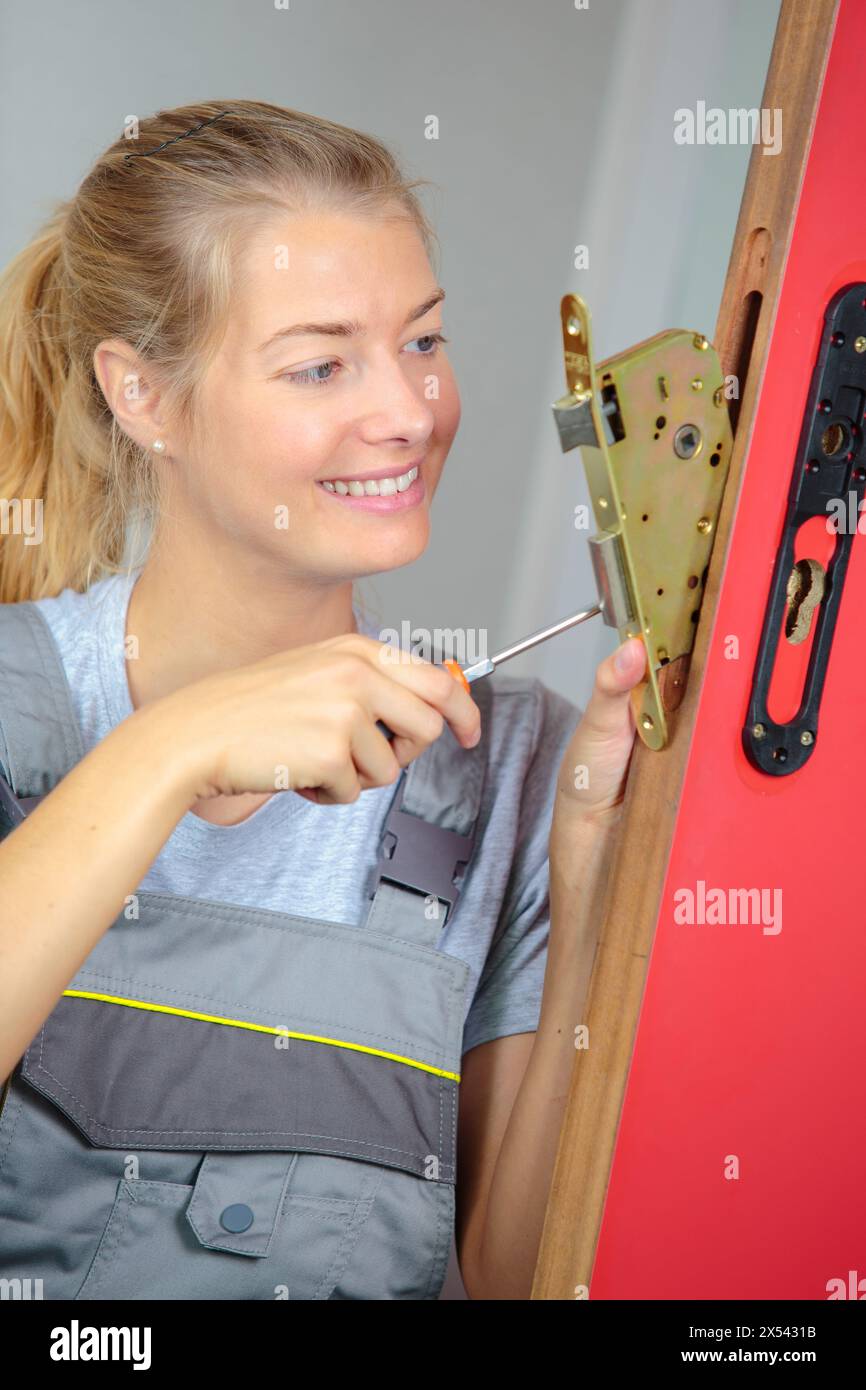 a woman woman worker fixing the door Stock Photo - Alamy