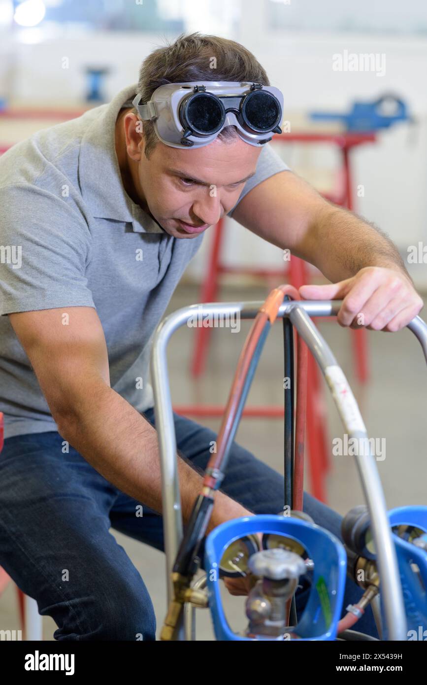 man wearing safety glasses before soldering Stock Photo - Alamy