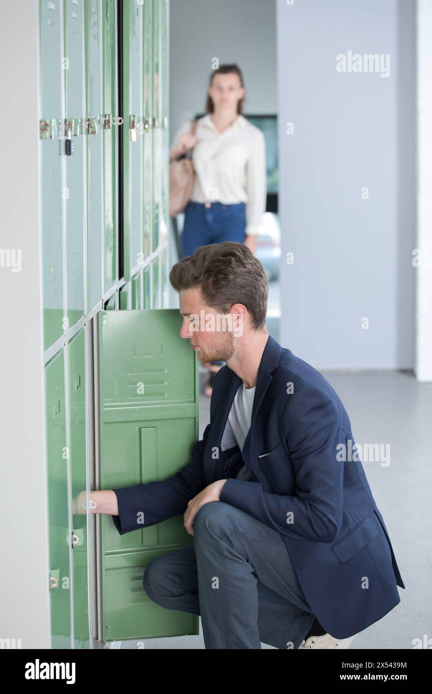 High School Boy Opening Locker Stock Photo - Alamy