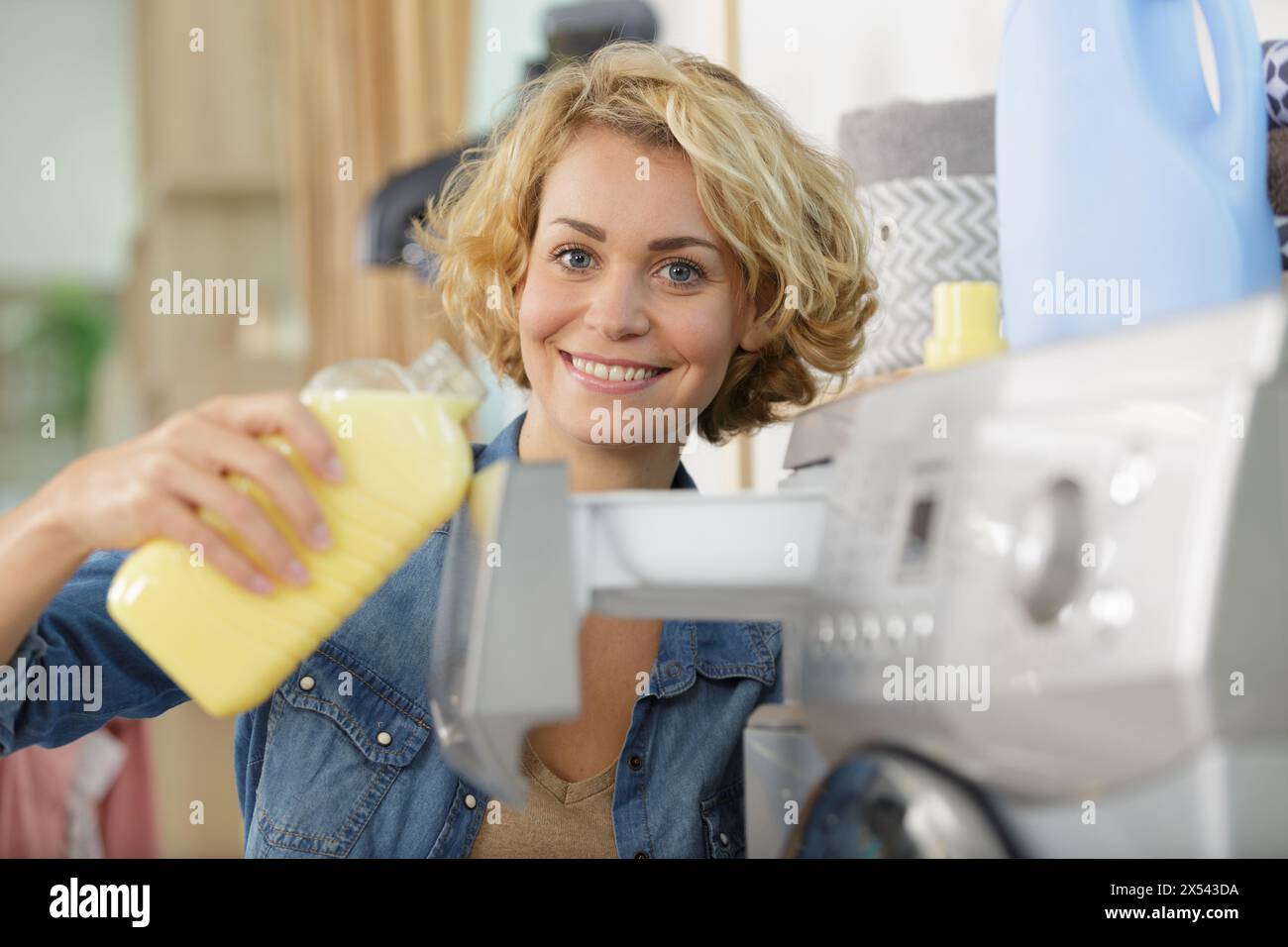Woman pouring fabric softener washing hi-res stock photography and ...
