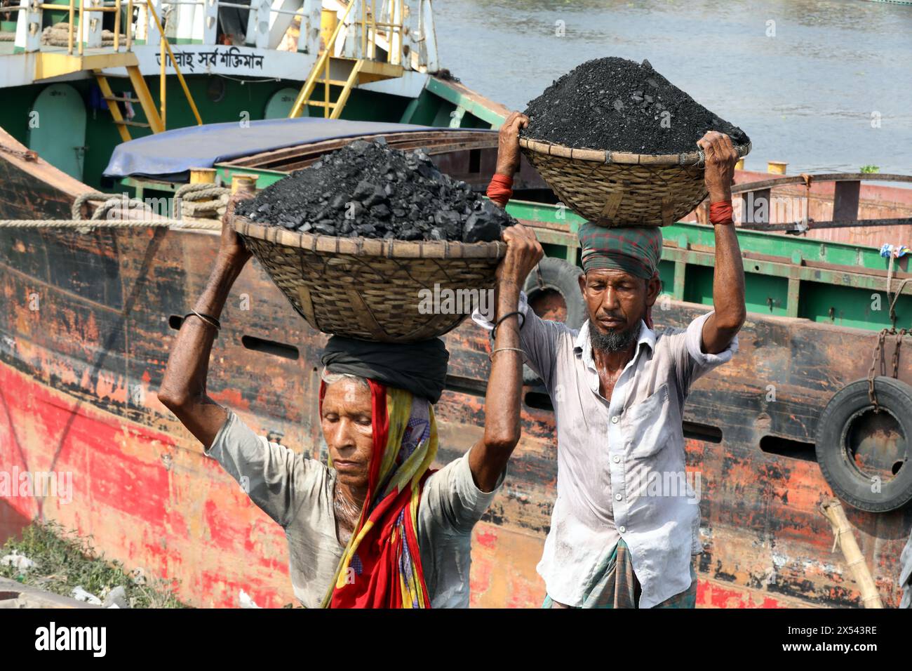 Dhaka, Bangladesh. 30th Apr, 2024. Labourers are unloading coal from a ...