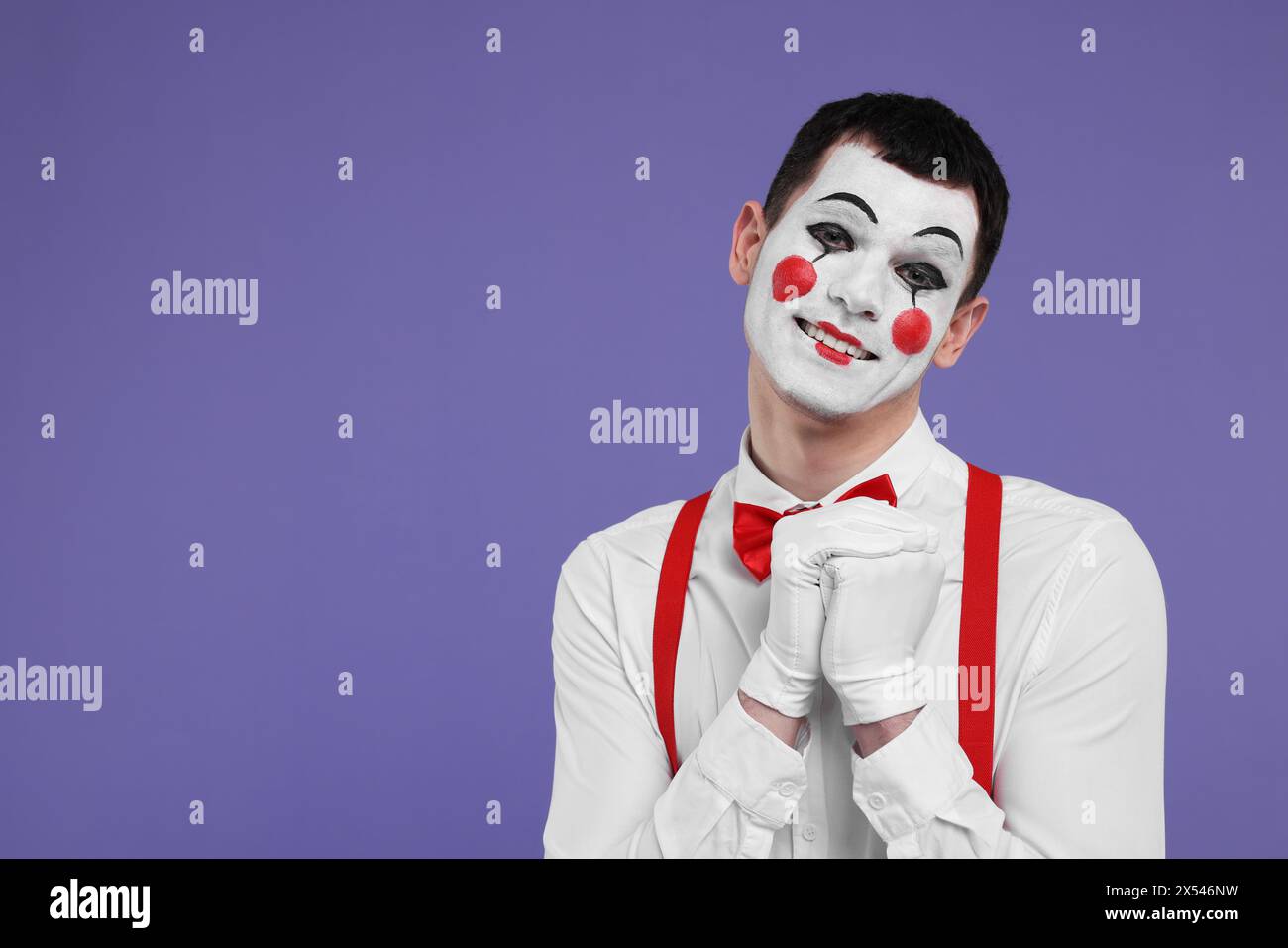 Funny mime artist posing on purple background. Space for text Stock ...