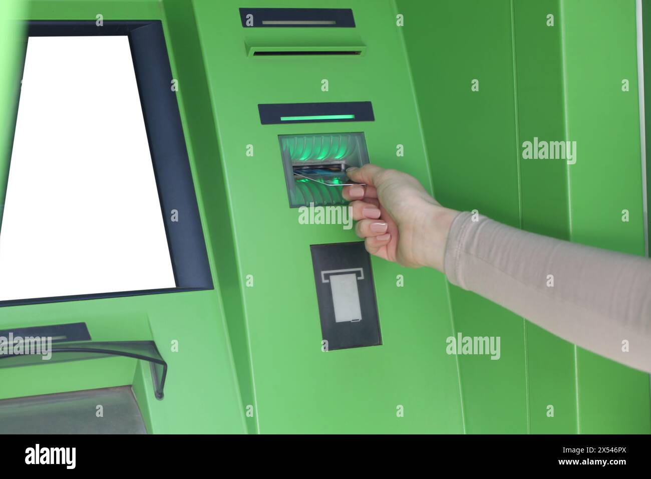 Woman inserting credit card into green cash machine, closeup Stock ...