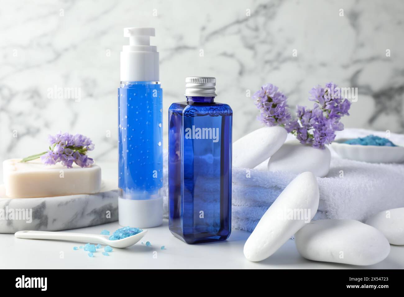Spa composition. Bottles of cosmetic products, sea salt, stones, soap ...
