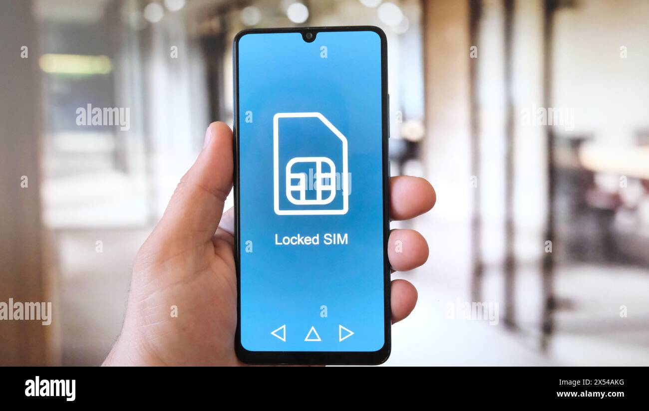 Sim locked message. White male hand in front of office background Stock ...