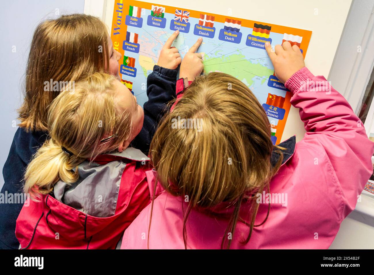 Primary school children looking at a map of the world during a lesson ...