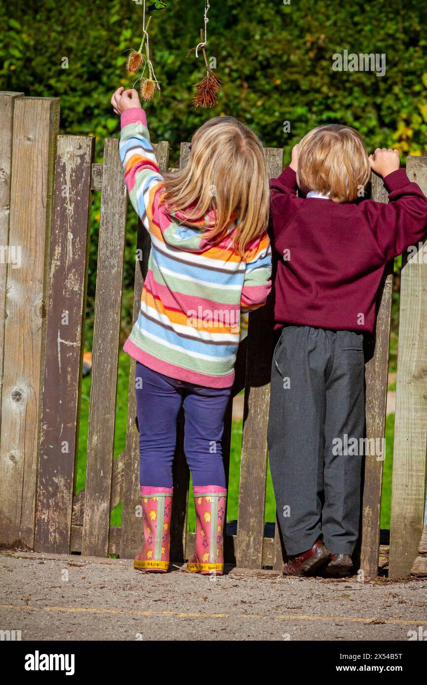 Primary schoolchildren playing in a school playground in a break ...