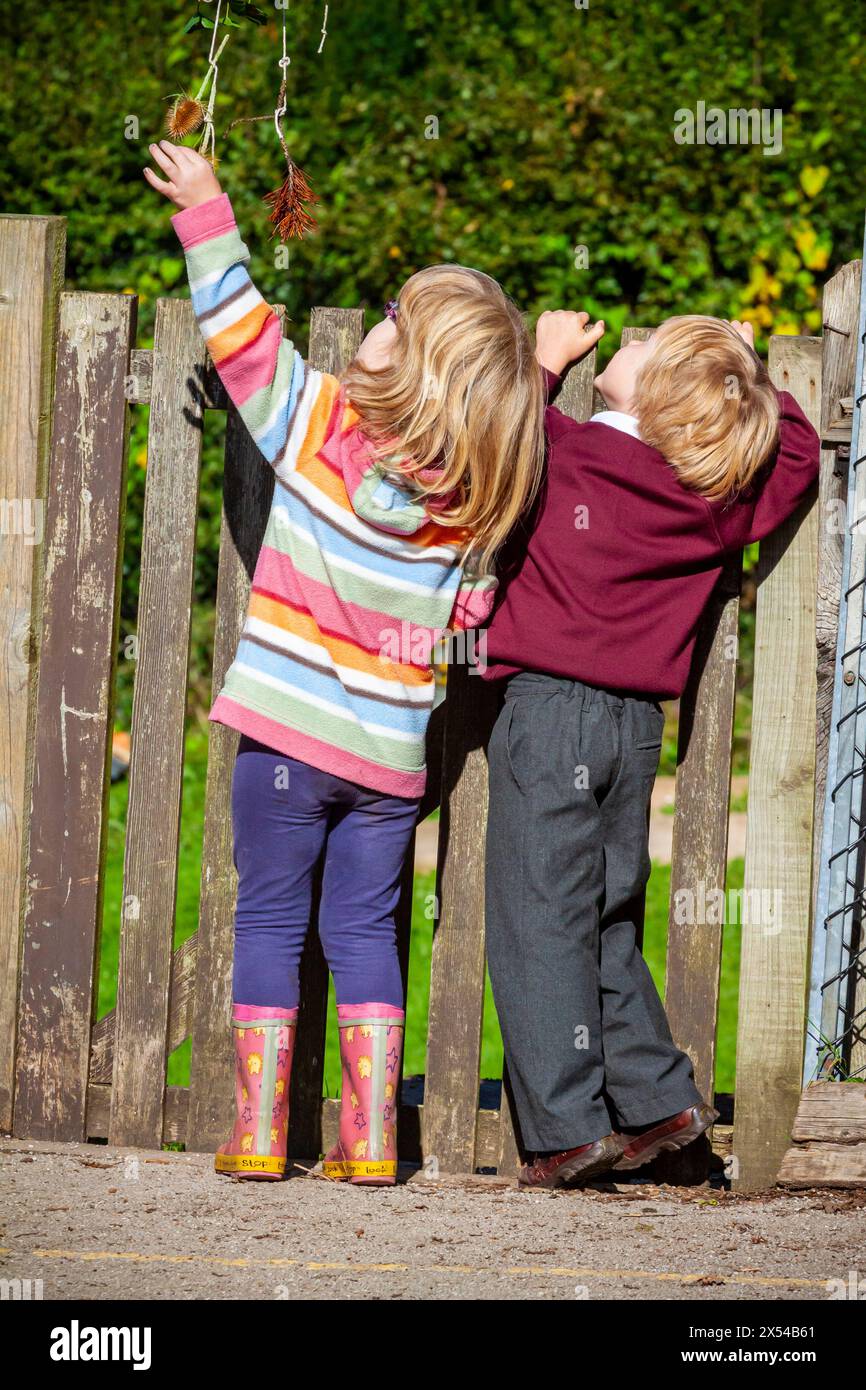 Primary schoolchildren playing in a school playground in a break ...