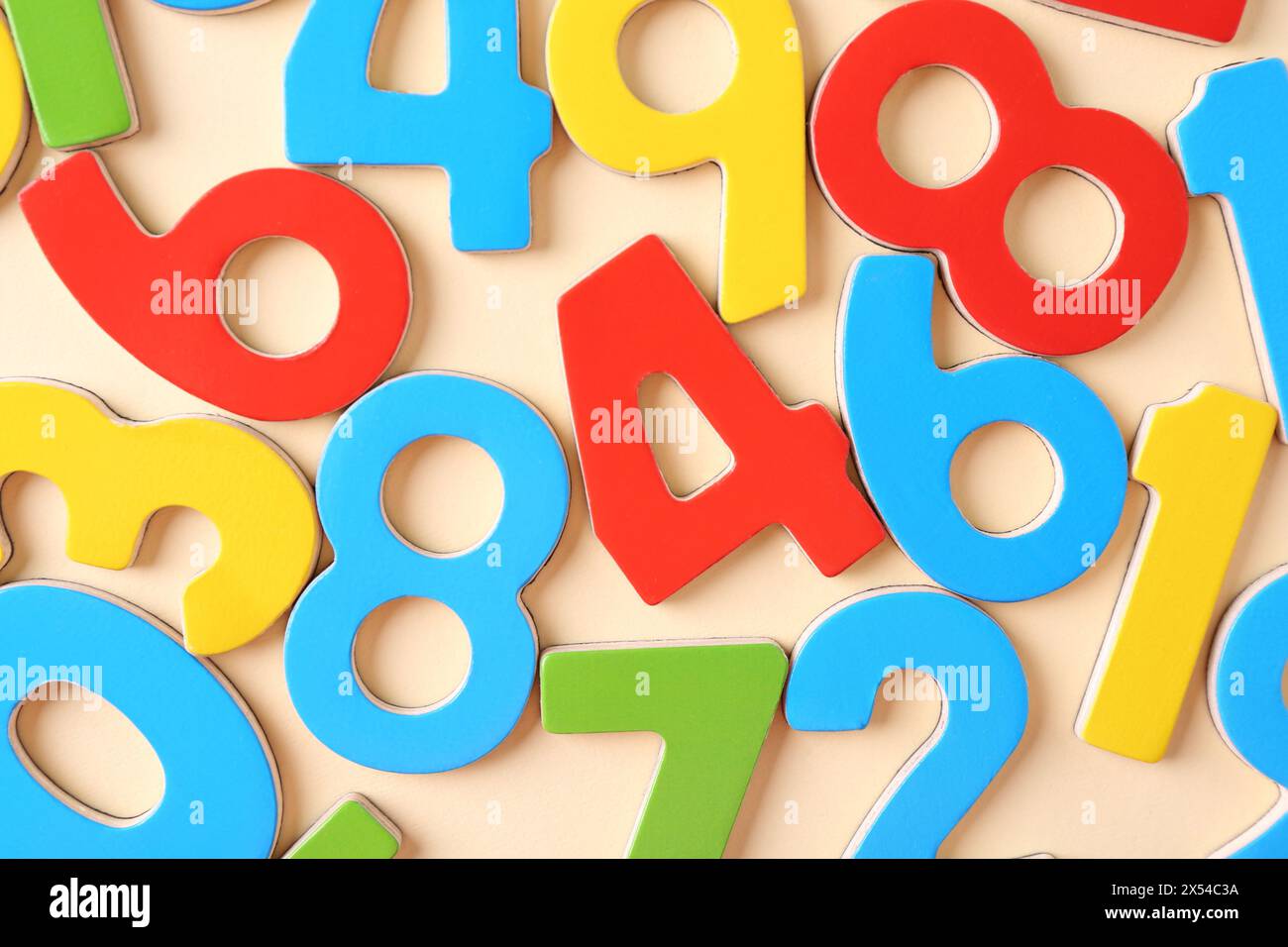 Colorful numbers on beige background, flat lay Stock Photo - Alamy