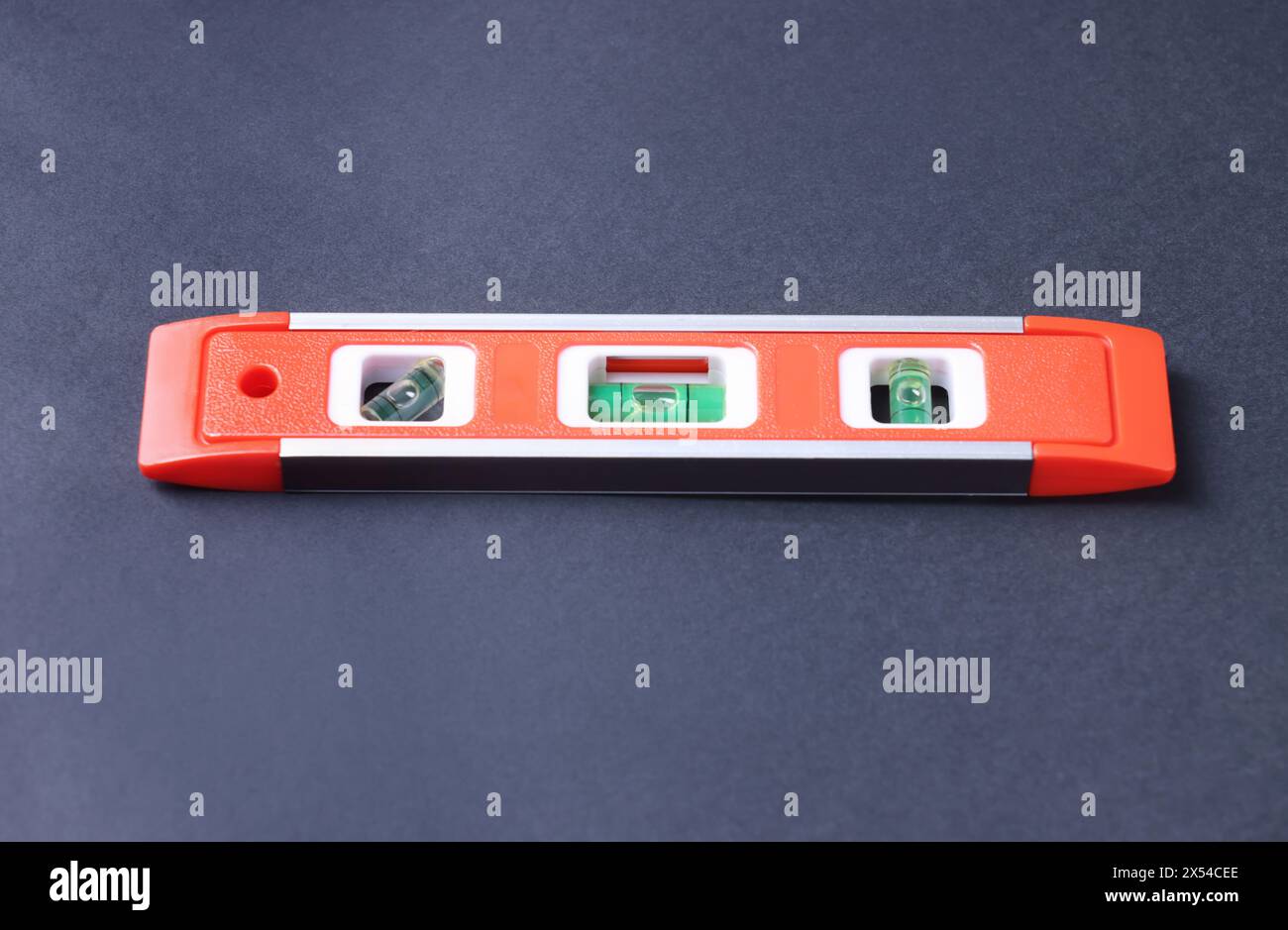 Building level on dark background. Construction tool Stock Photo - Alamy