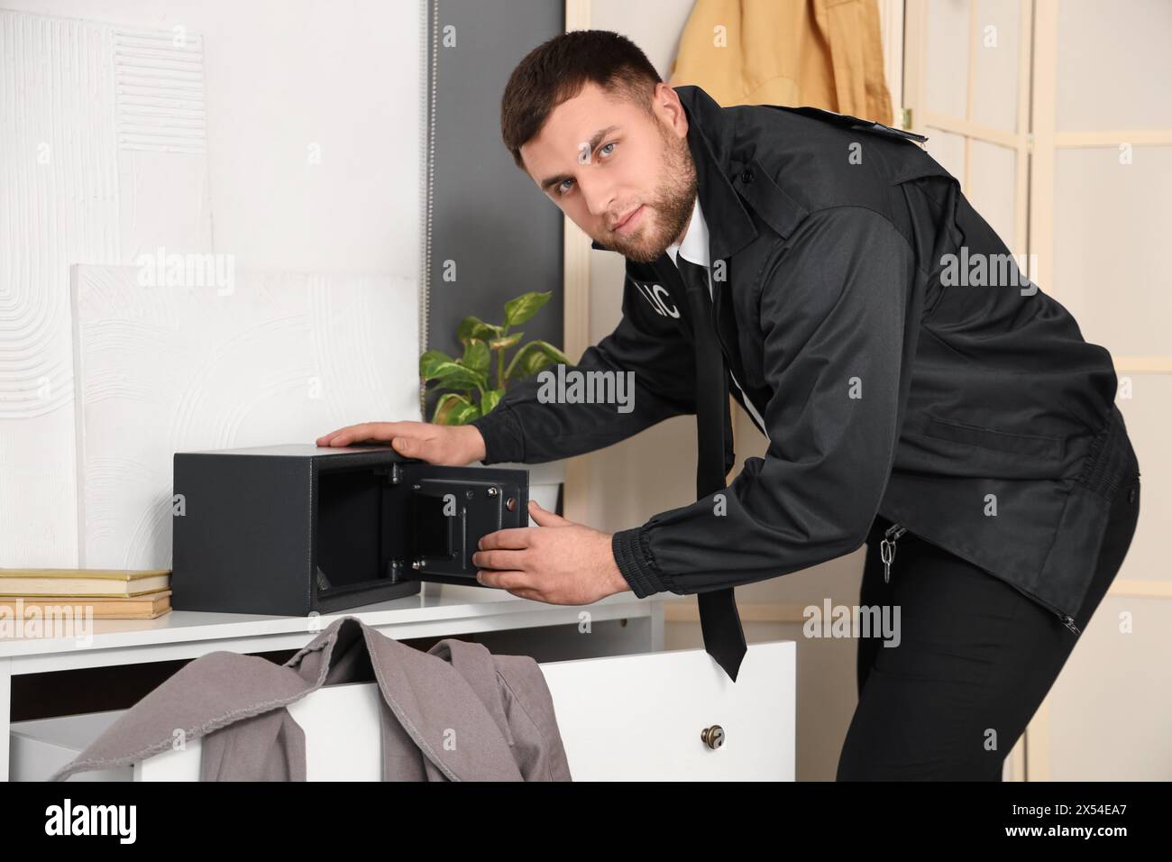 Male police officer working at crime scene indoors Stock Photo - Alamy