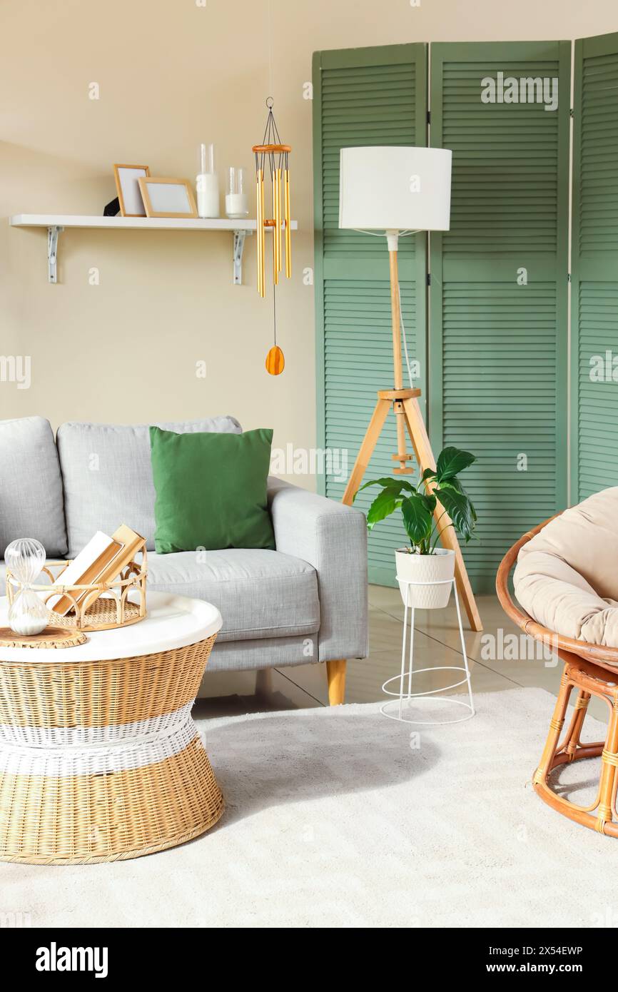 Interior of light living room with wind chime, sofa and lamp Stock ...