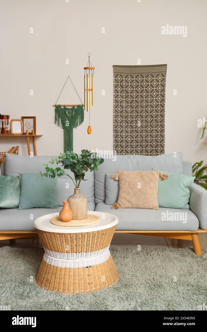 Interior of living room with wind chime, sofa and table Stock Photo - Alamy