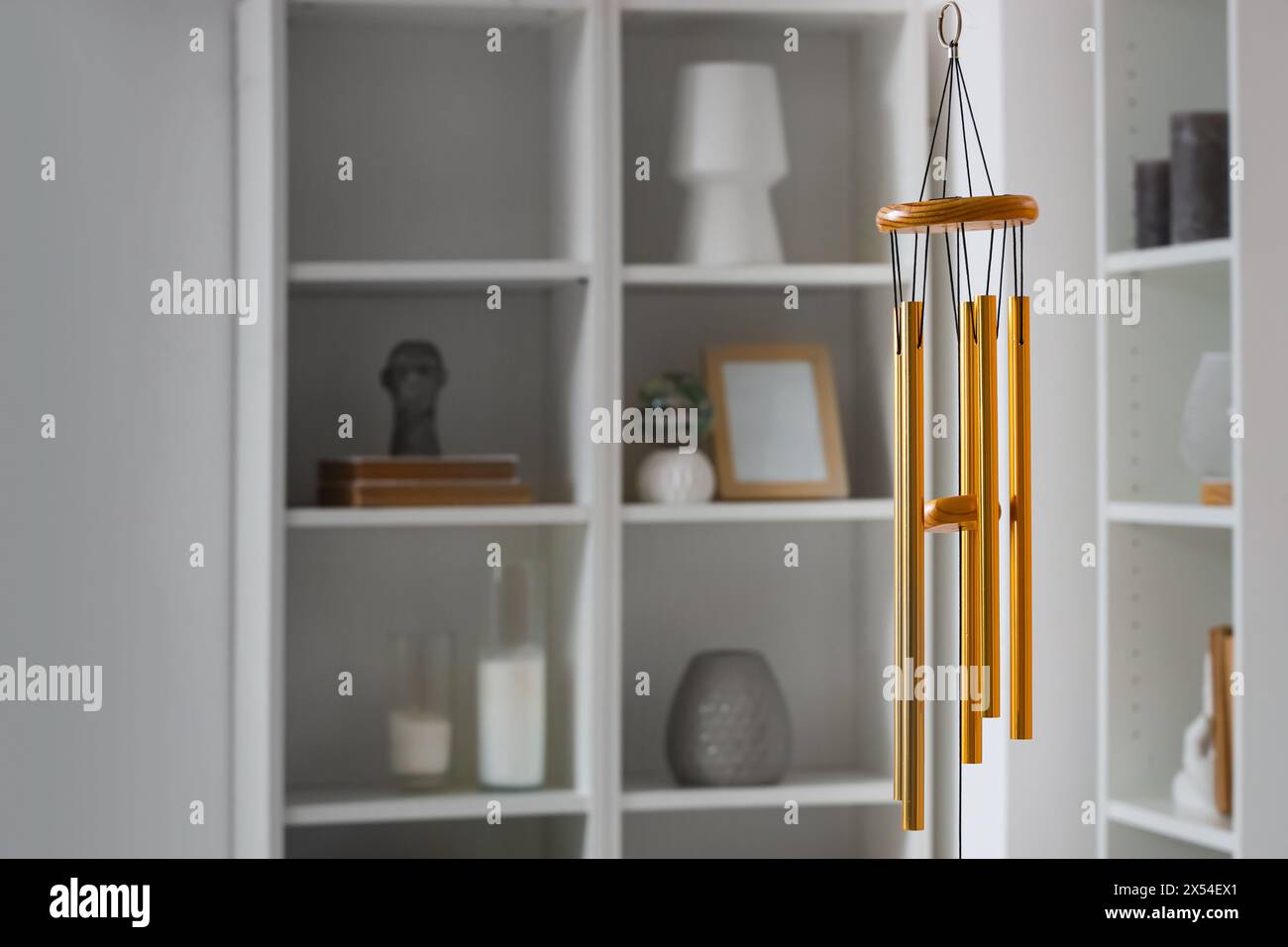 Golden wind chime hanging in light bedroom, closeup Stock Photo - Alamy