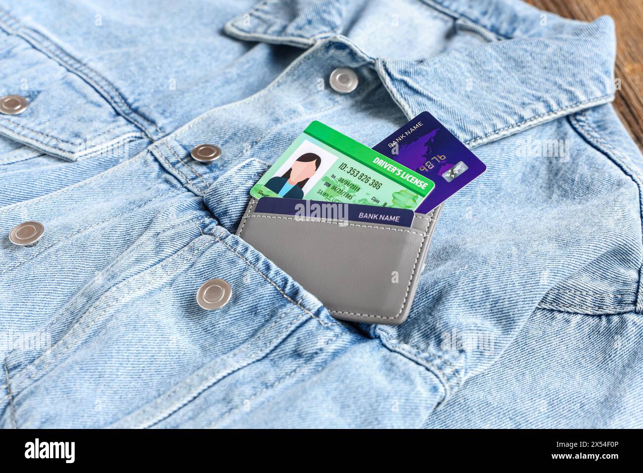 Grey credit holder with cards and drivers license in jeans jacket ...