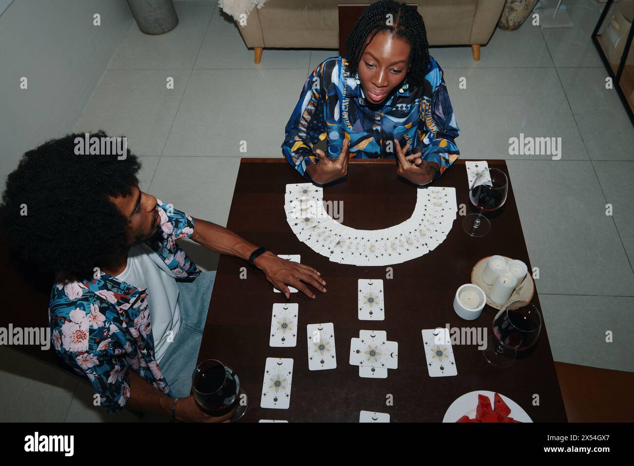 Young Black woman doing tarot spread for best friend Stock Photo - Alamy