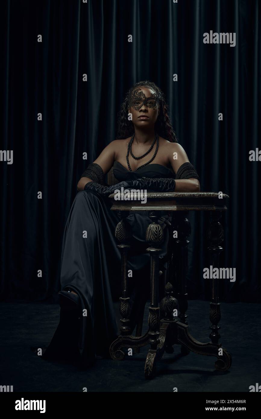 Confident, statuesque African-American woman seated in classic vintage ...