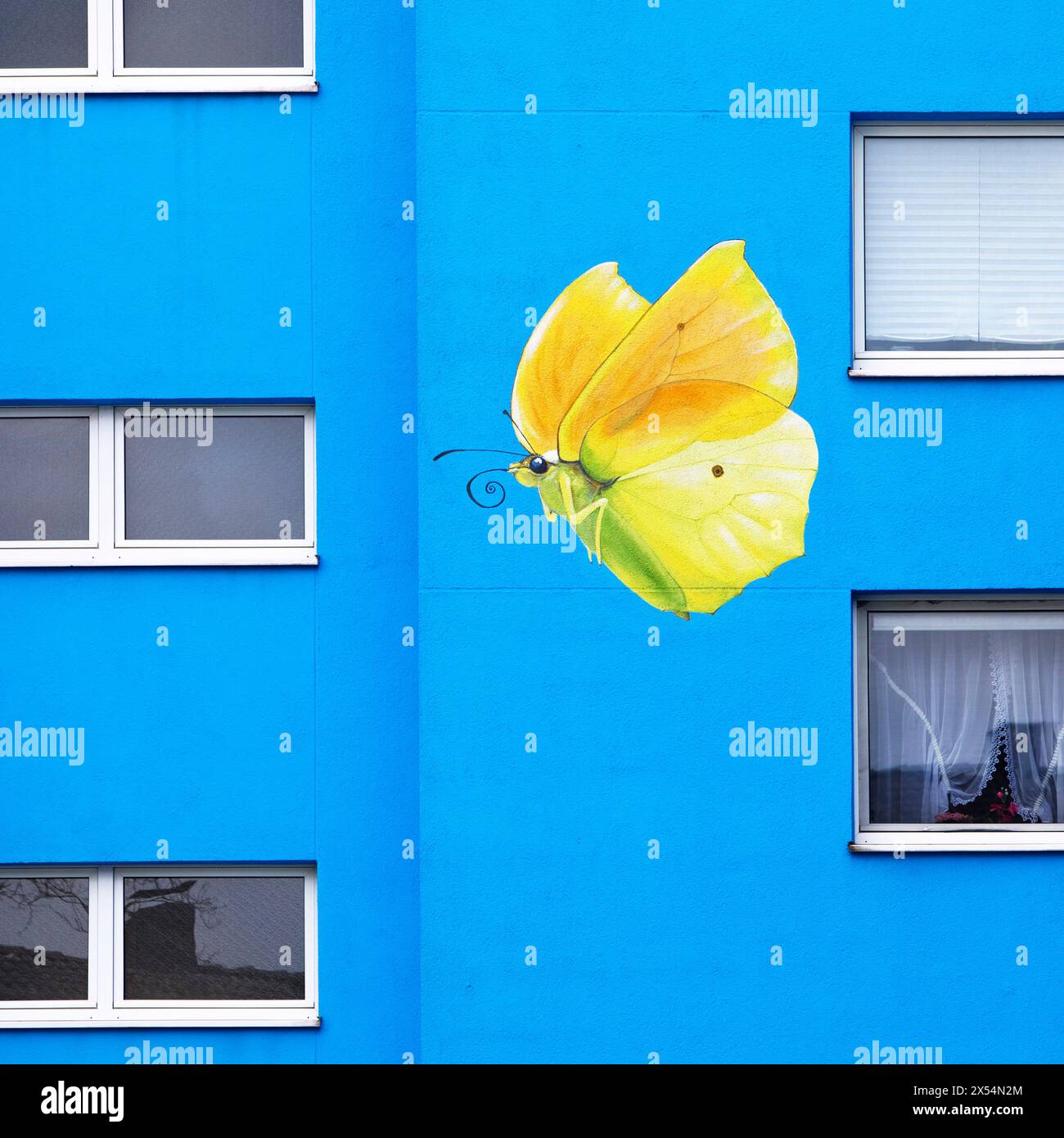 Sunflower house, yellow brimstone, painted on the facade of a high-rise ...