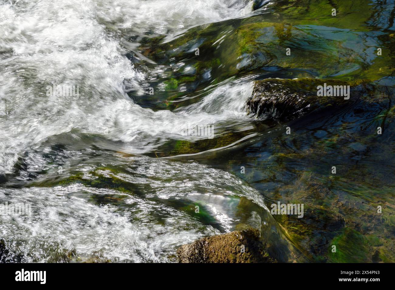 Water flowing over rocks, River Dove, Wolfscote Dale, Peak District ...
