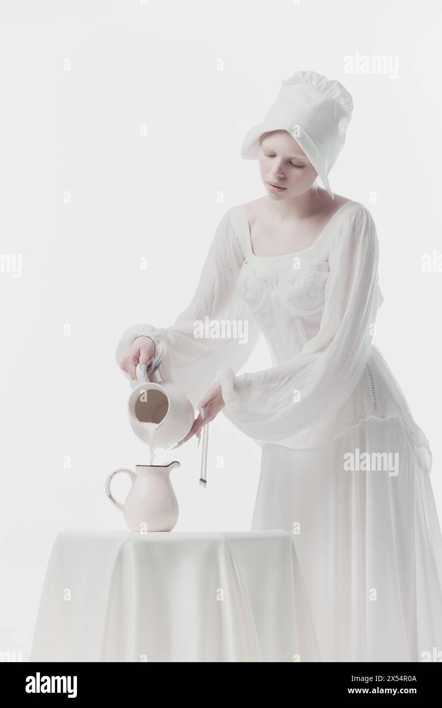Beautiful young woman dressed as medieval person, maid in white ...