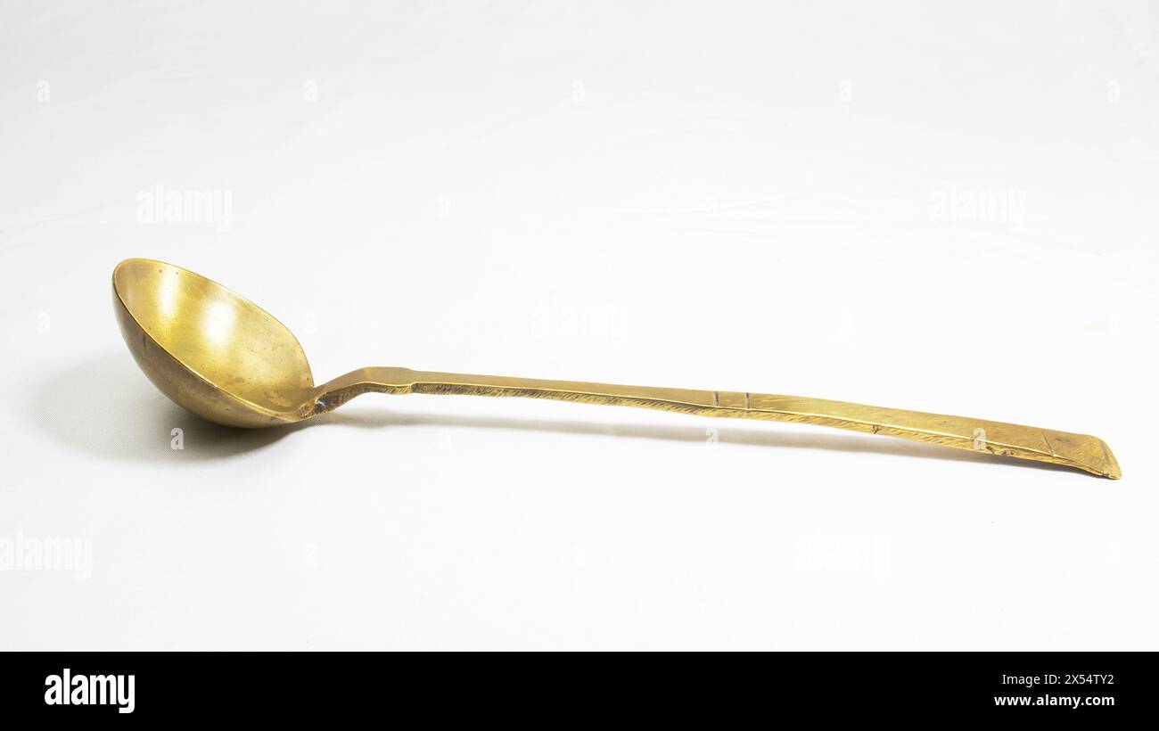 Empty golden brass spoon. traditional utensil for cooking and rituals ...