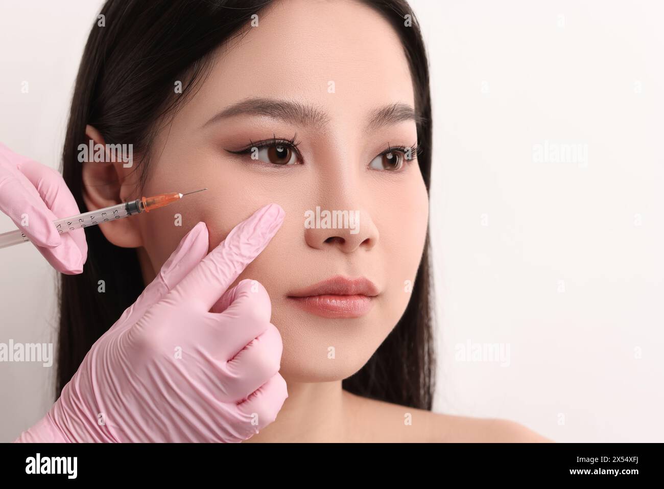 Woman getting facial injection on white background, closeup Stock Photo ...