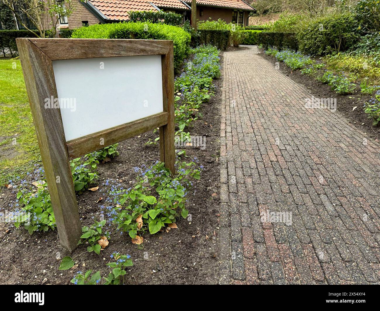 Sign board, pathway and beautiful building outdoors Stock Photo - Alamy