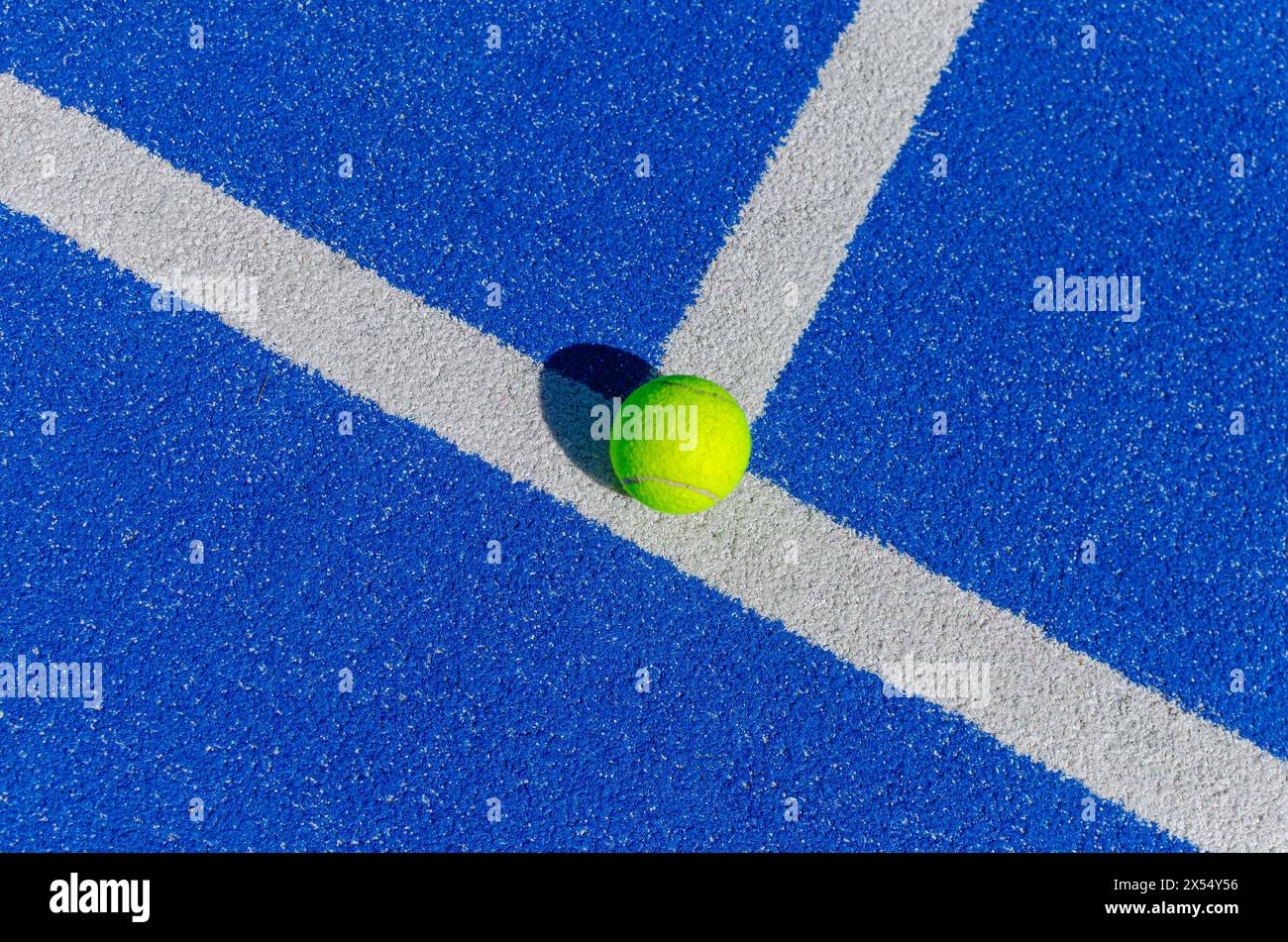 Padel ball on blue padel court Stock Photo - Alamy