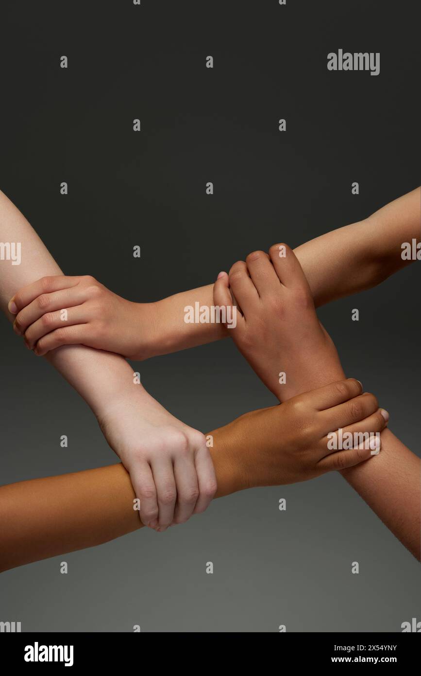 Group of children's hands holding on to each other, symbolizing work in ...