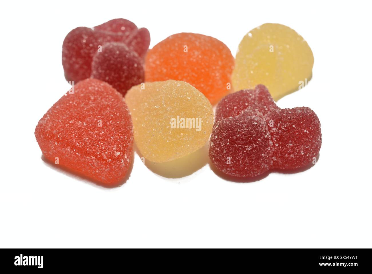 Marmalade candies of different tastes lie in a heap on a white ...