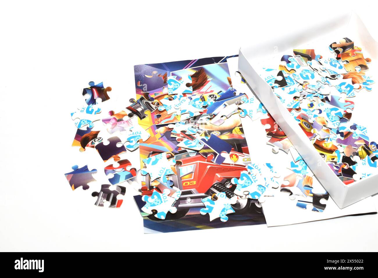 On a white background lies a cardboard box from which multi-colored ...