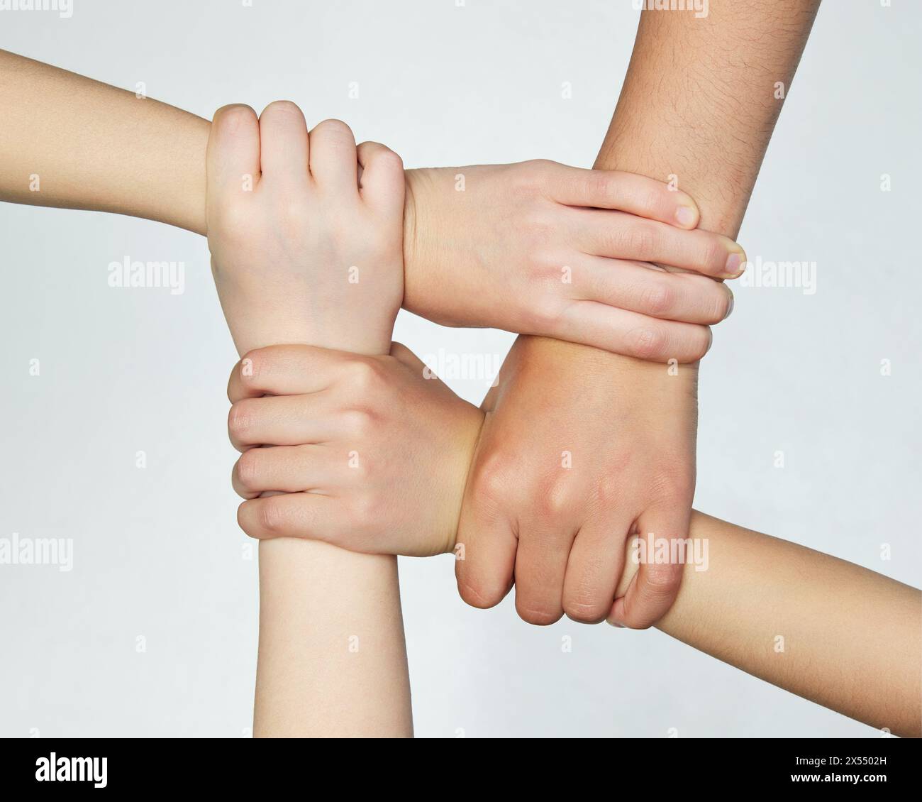 Group of children's hands holding on to each other, symbolizing work in ...