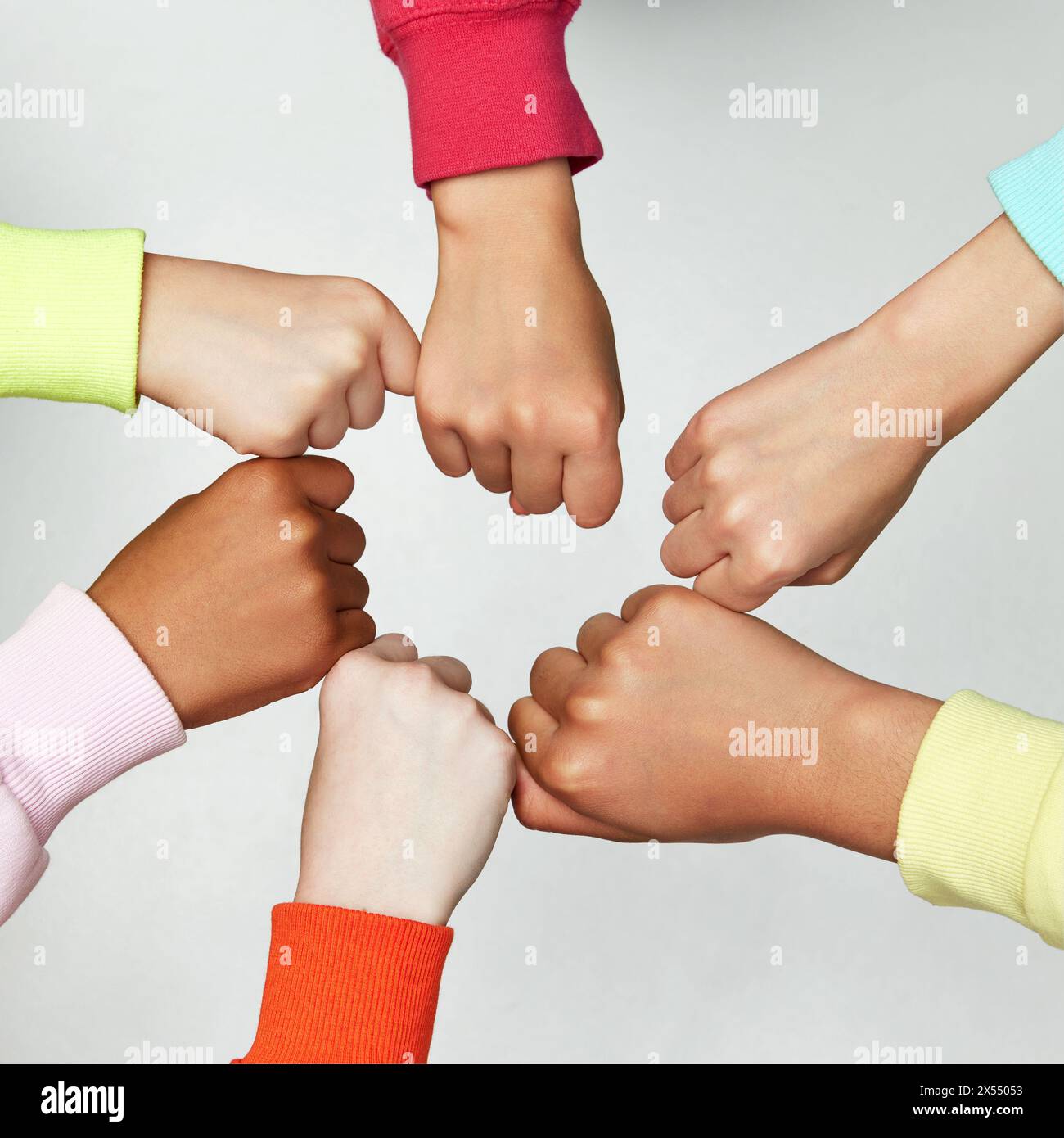 Teamwork. Close up of hands clenched in fist meeting join hands against ...