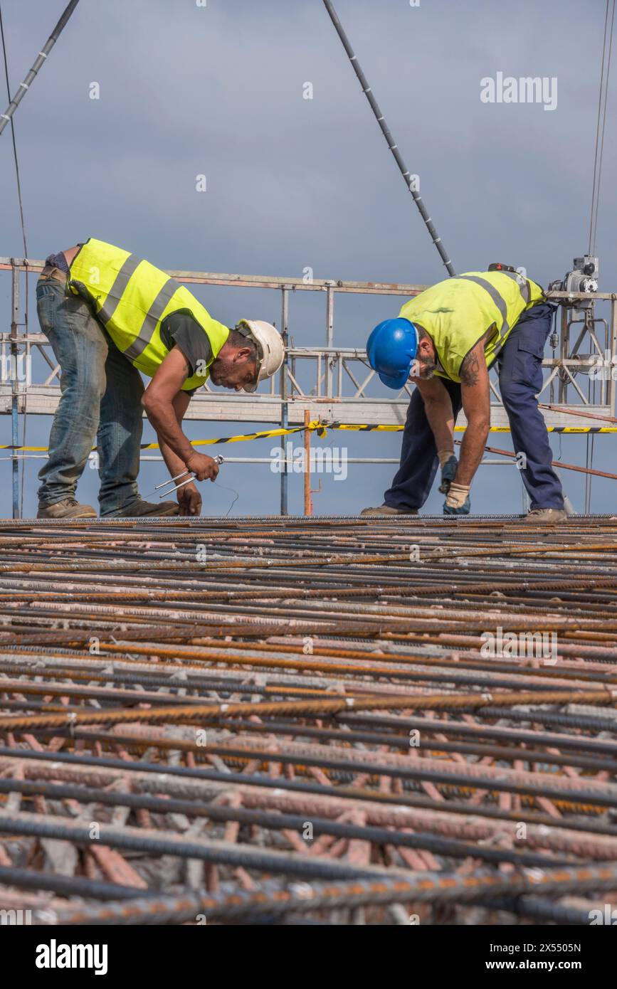 Workers placing steel beams on a bridge Stock Photo - Alamy