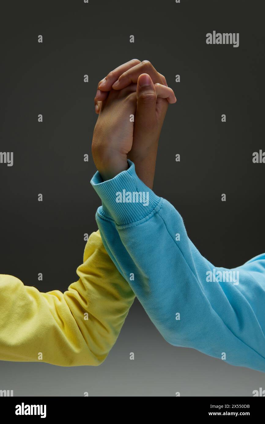 Two hands gripping each other tightly symbolizes unity and support ...