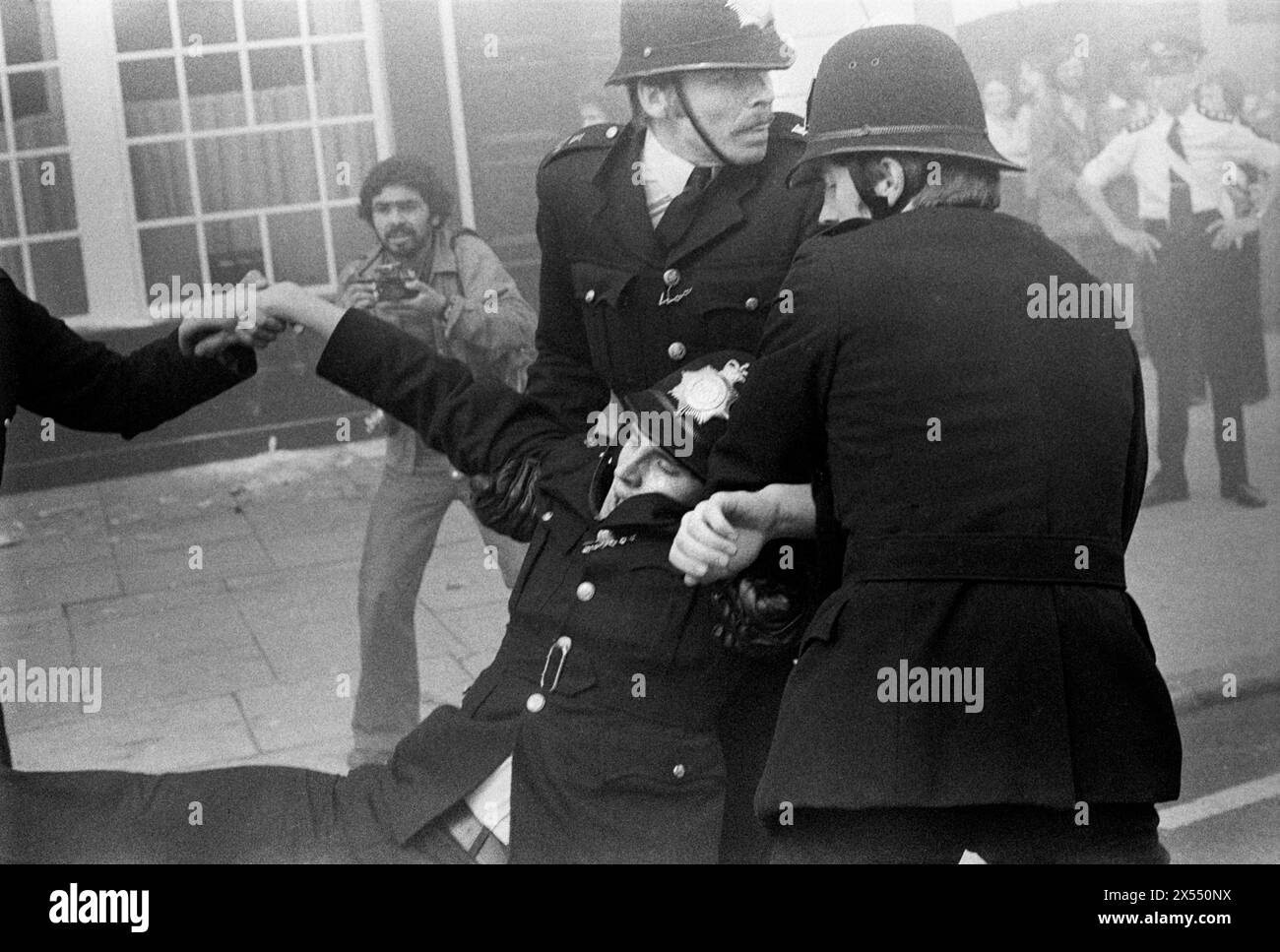 Police officer wounded in violent riots London UK 1970s. Battle of ...