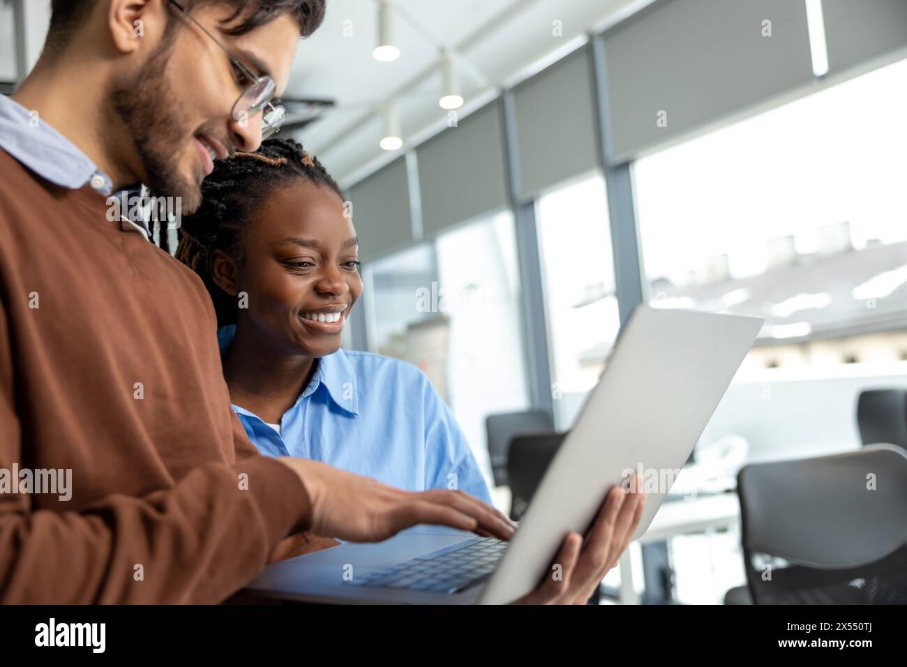 Diverse colleagues collaborating on project together Stock Photo - Alamy
