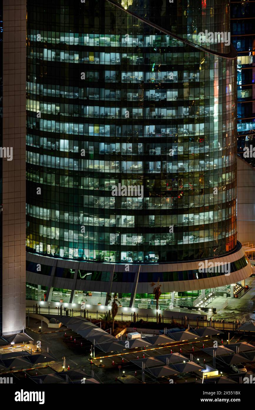Blinking light in window of the multi-story building of glass and steel ...