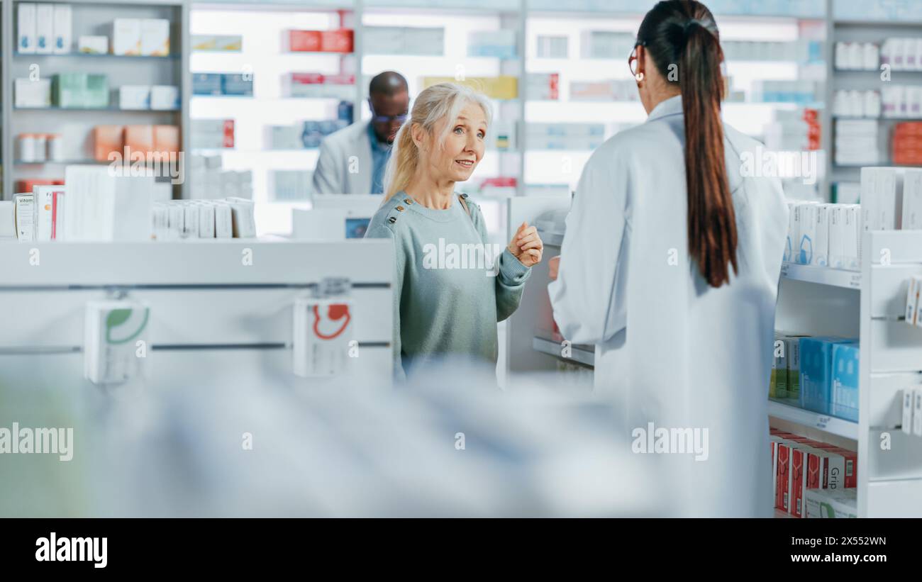 Professional pharmacist helping female customer hi-res stock ...