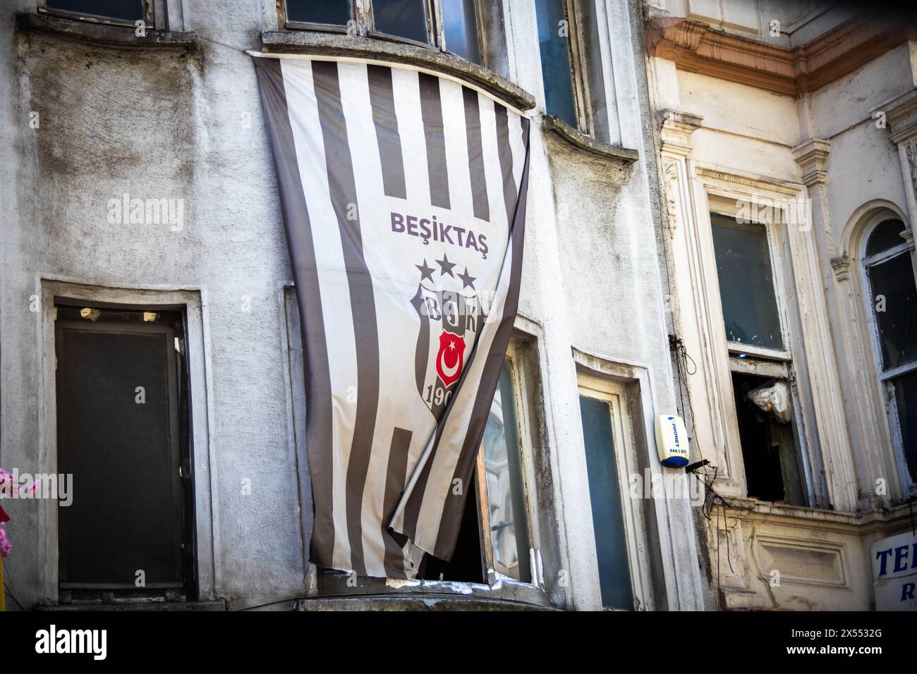 A Beşiktaş flag proudly displayed from a window, symbolizing local ...