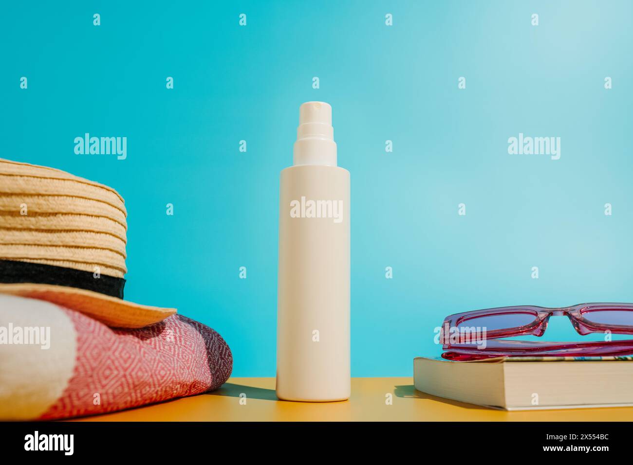 Blank white sunscreen bottle sun hat sunglasses and books on beach in ...