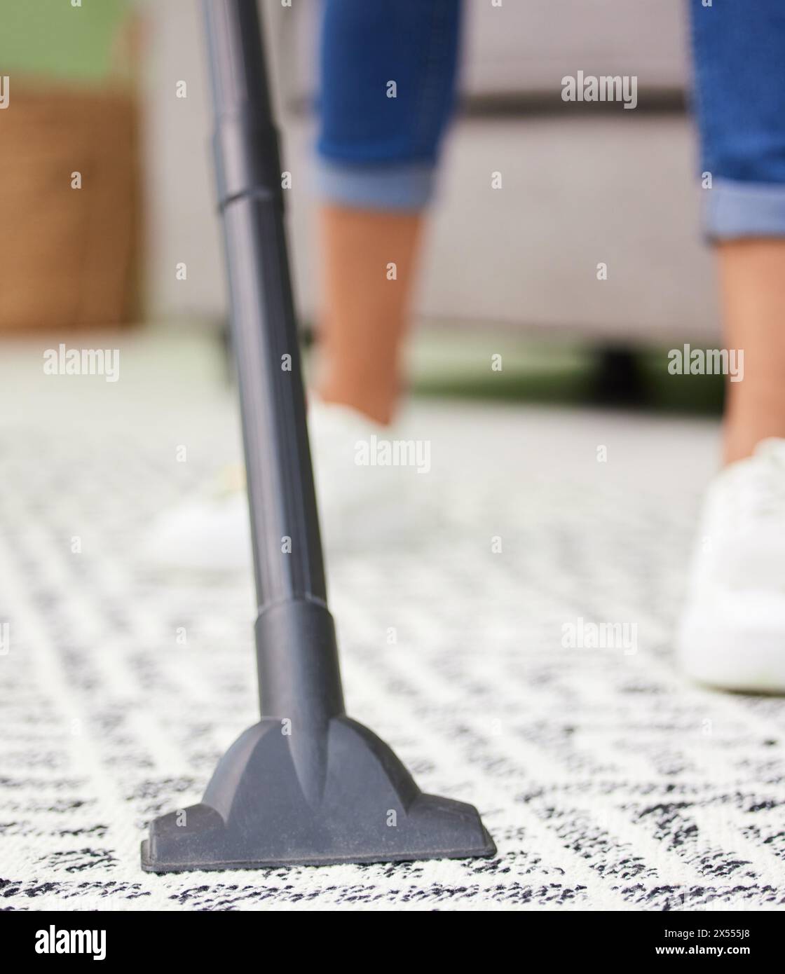 Person, closeup and vacuum for carpet in home, living room and services ...