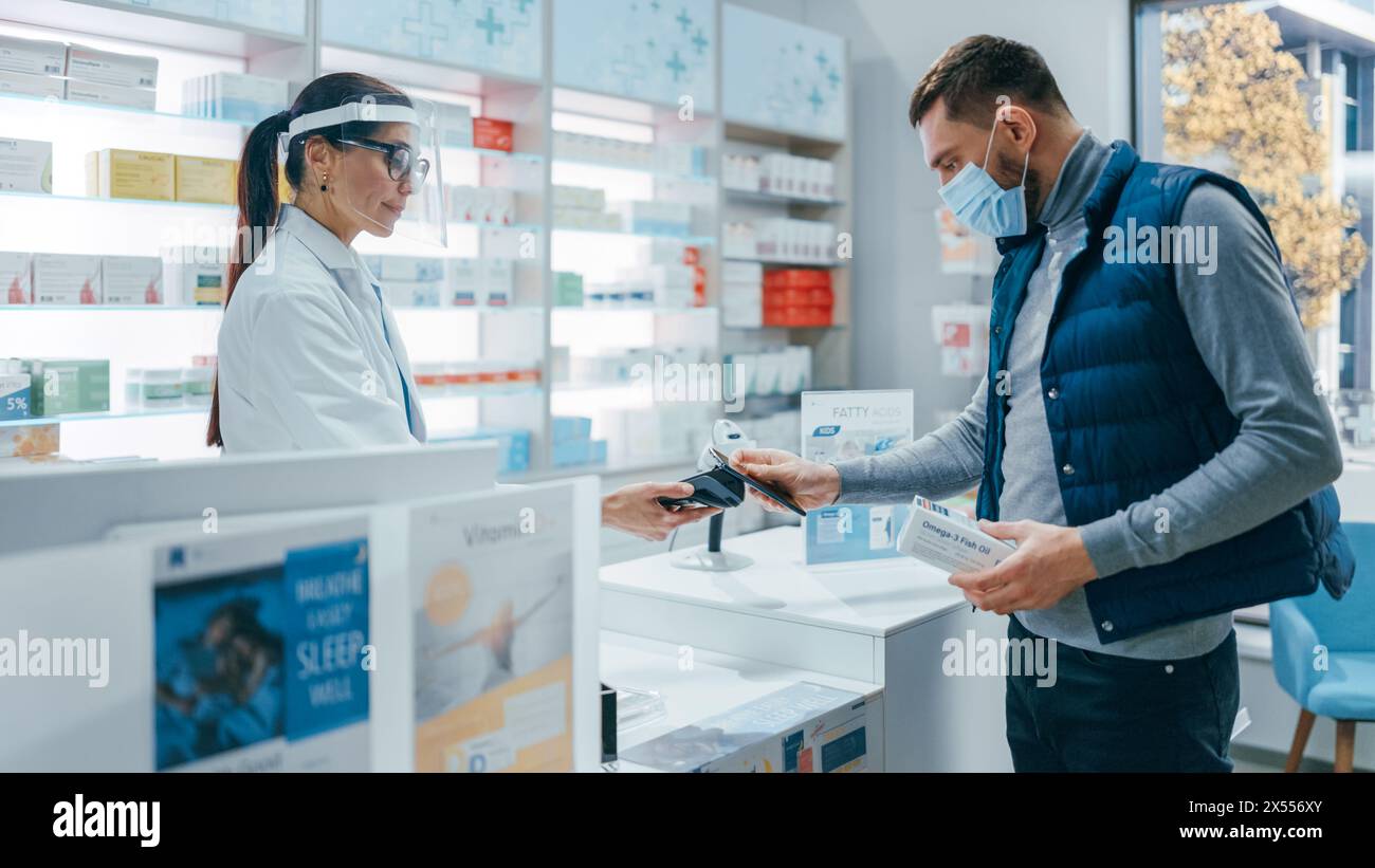 Pharmacy Drugstore Checkout Counter: Female Pharmacist Wearing Face ...
